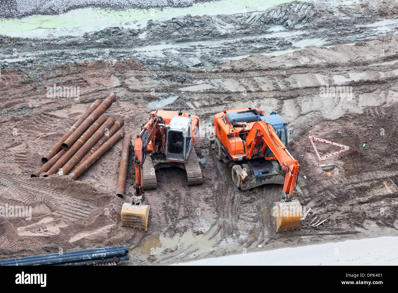 Two excavator at dirty construction site Stock Photo - Alamy