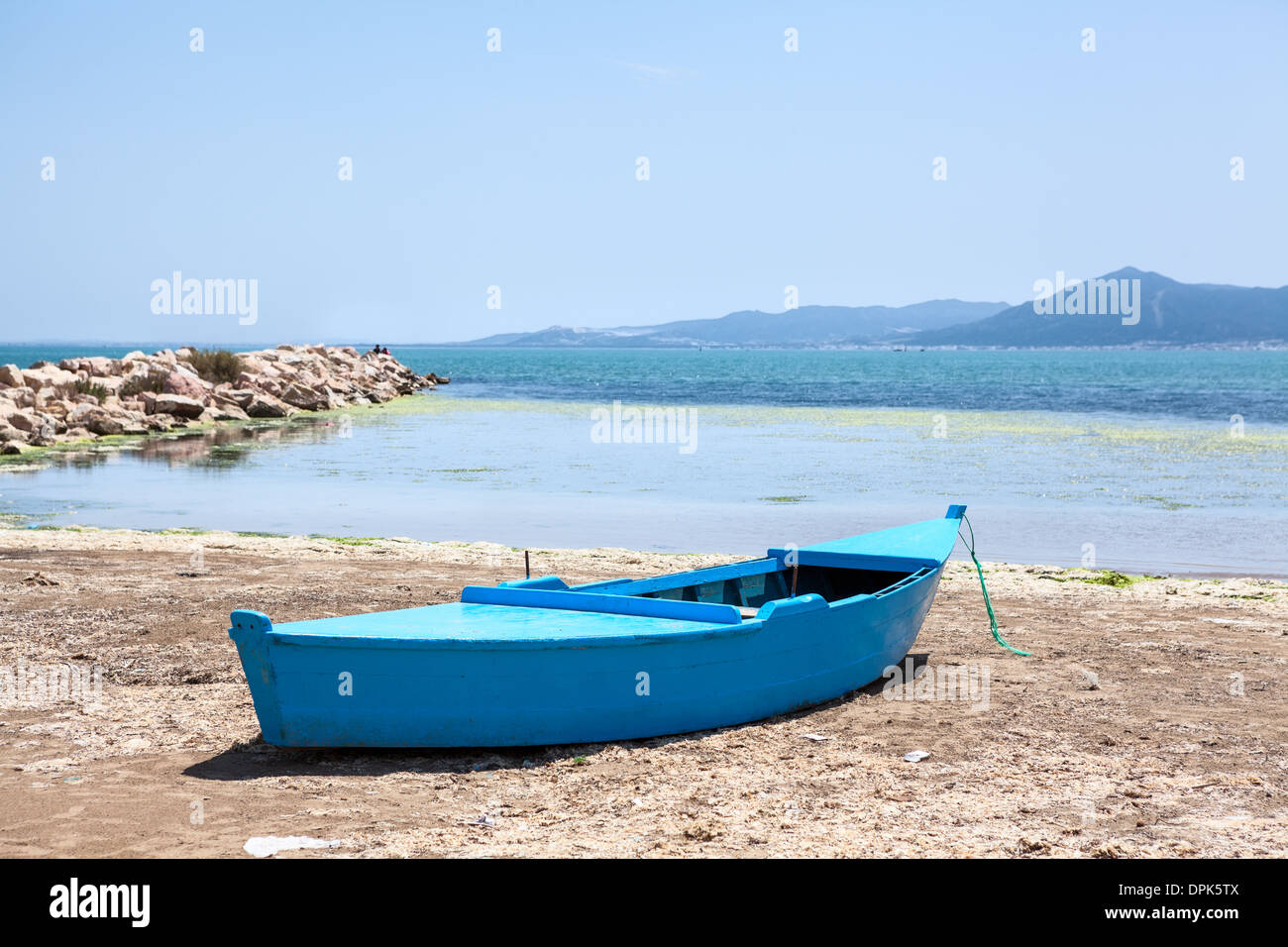 Sea bay and a boat pulled out on a sandy beach in the city of Carthage ...