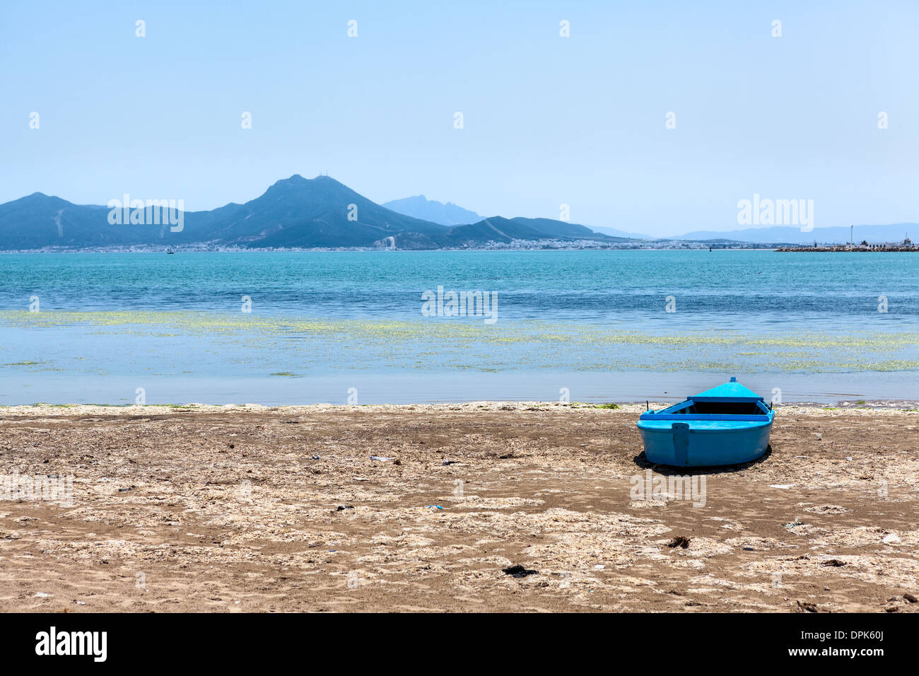 Sea bay and a boat pulled out on a sandy beach in the city of Carthage ...