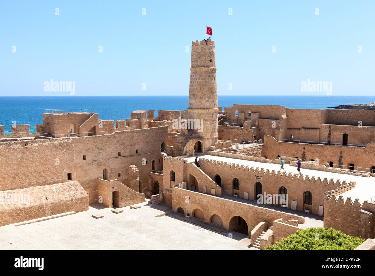 Courtyard Ribat fortress and a watchtower with red Tunisian flag on the ...