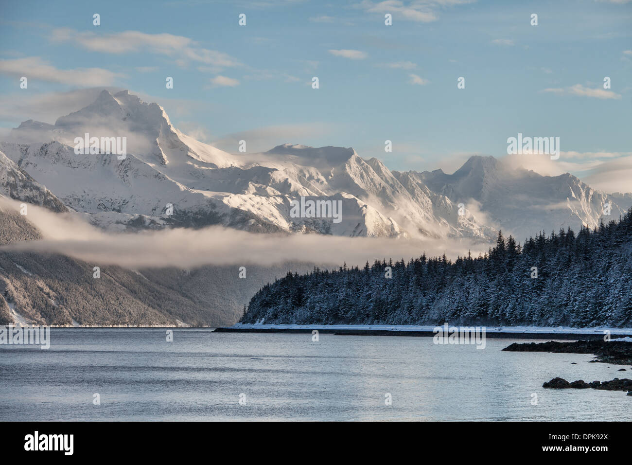 View of tall mountains from Viking Cove in southeast Alaska in winter ...