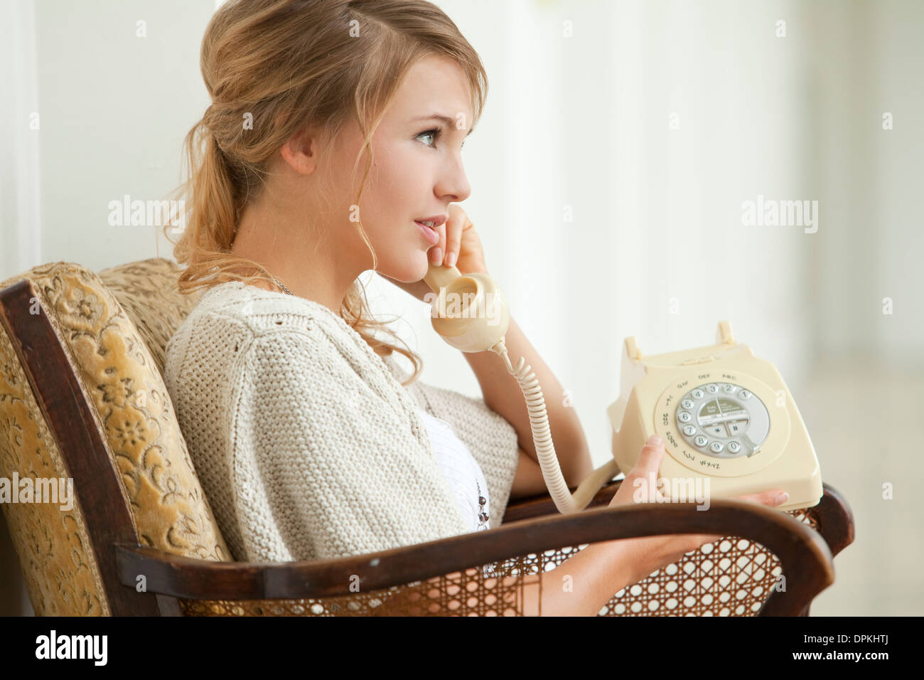 Young woman phoning with old phone Stock Photo - Alamy