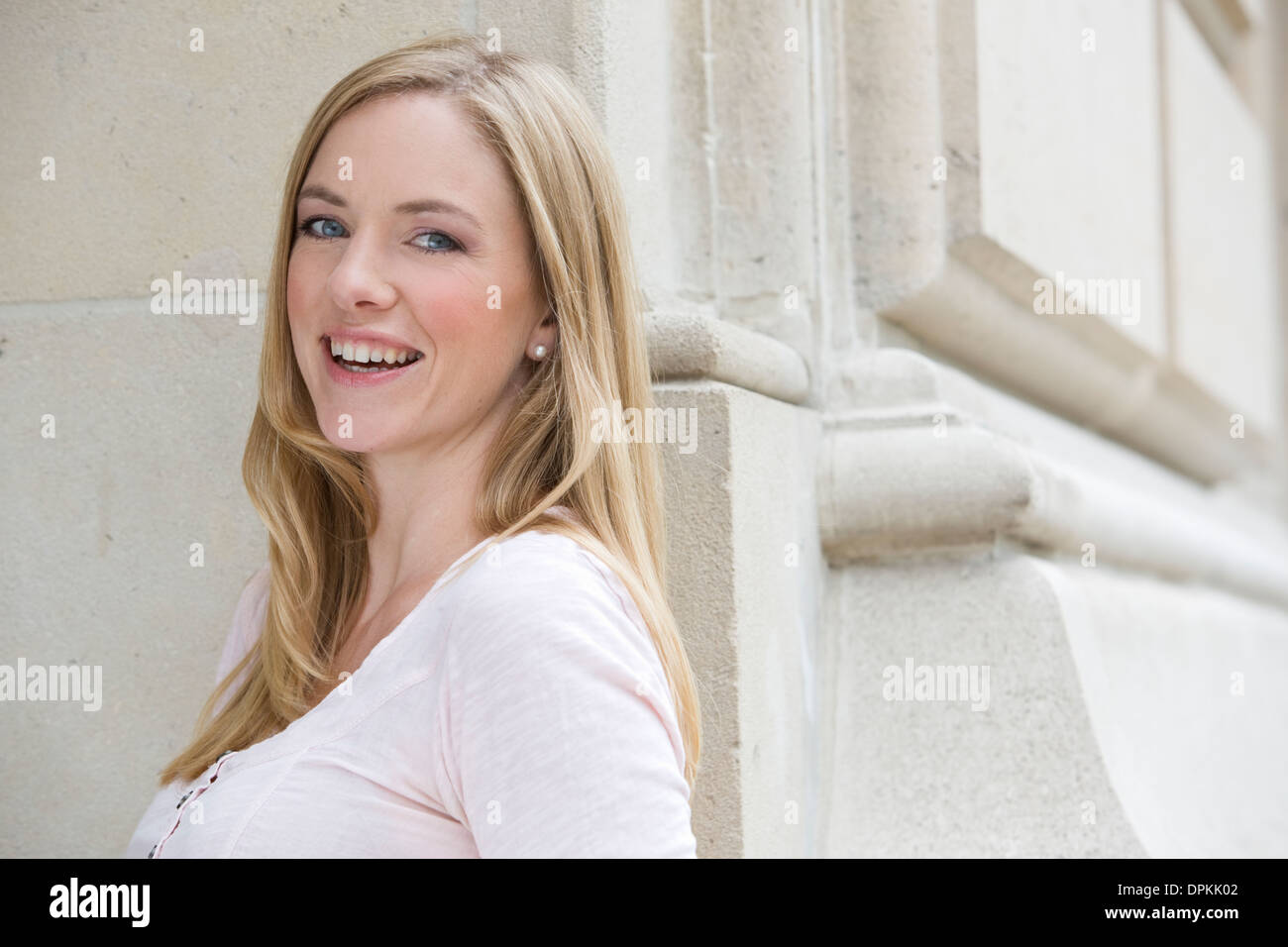 Young smiling woman stands hi-res stock photography and images - Alamy