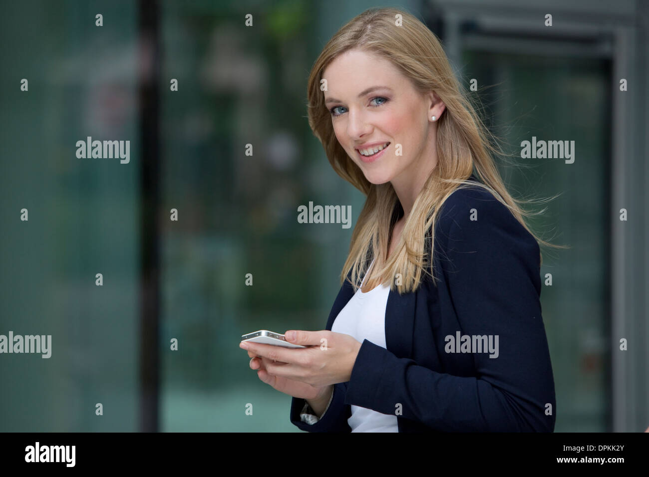 Woman smiles using smartphone hi-res stock photography and images - Alamy