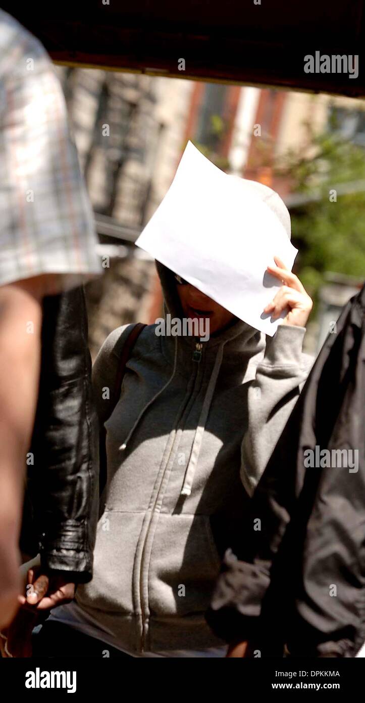 Apr. 28, 2006 - New York, New York, USA - Scarlett Johansson hides from ...