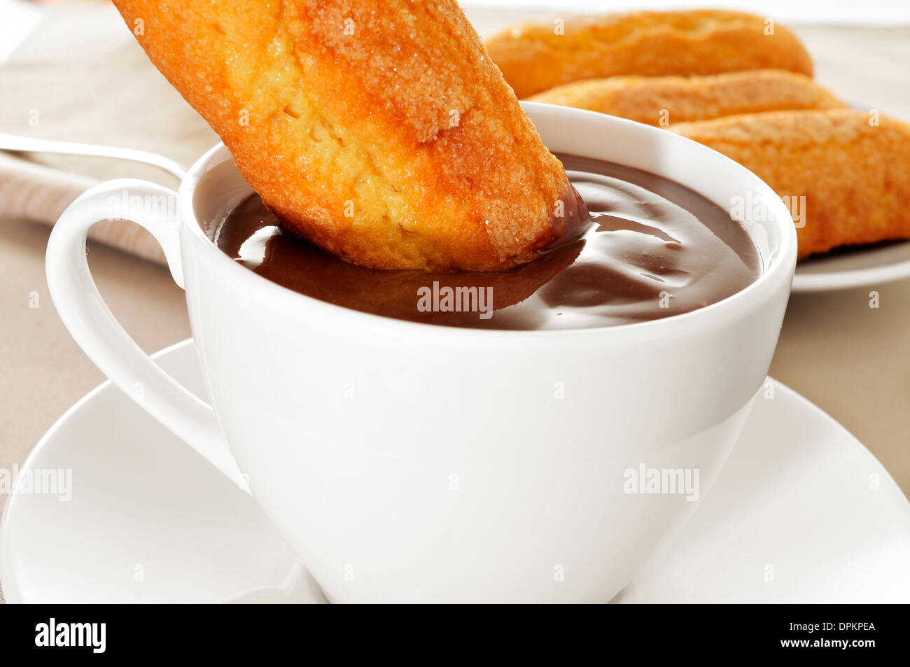 a cup of spanish hot chocolate and some pastries to dip in Stock Photo ...