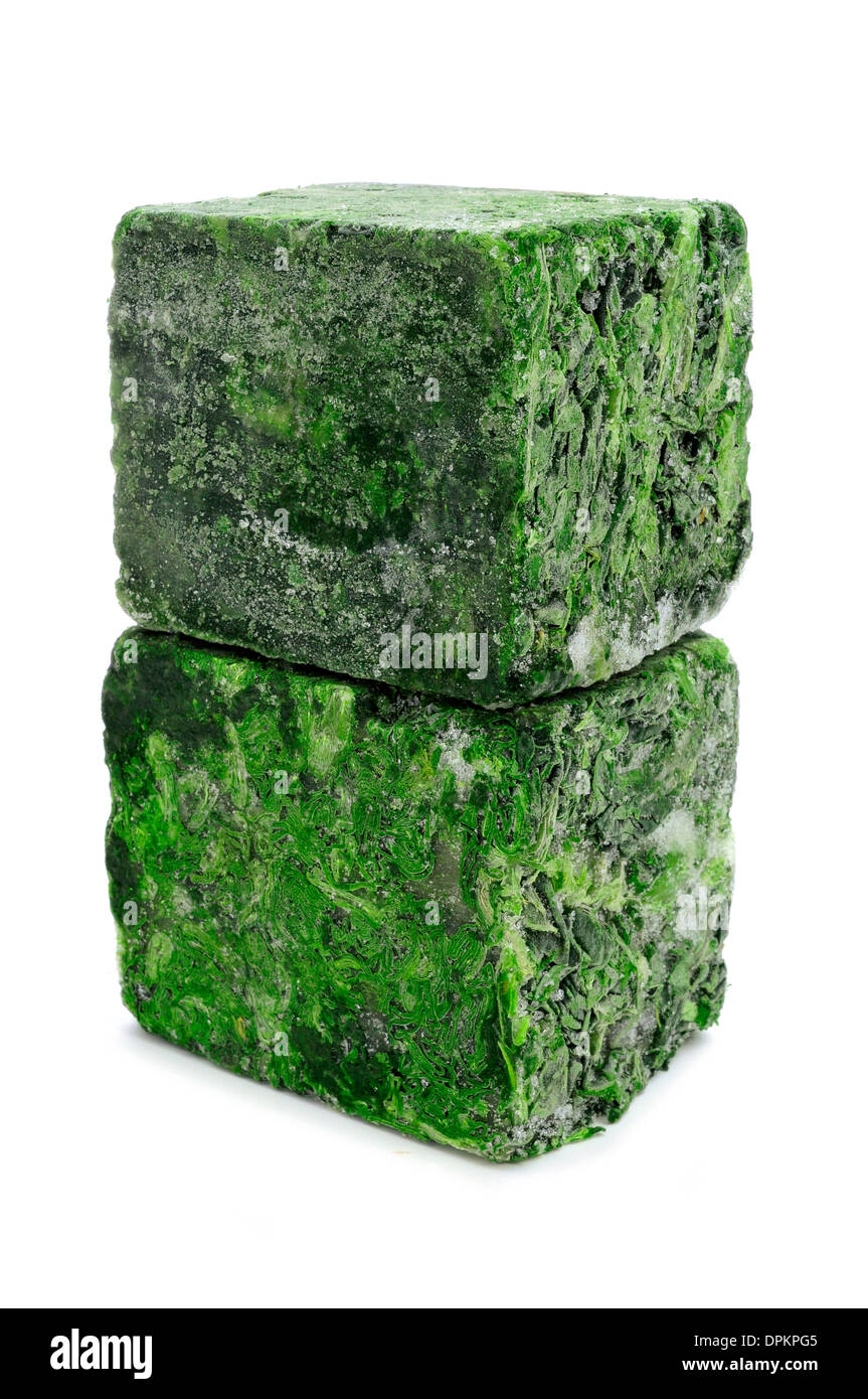 some blocks of frozen spinach on a white background Stock Photo - Alamy