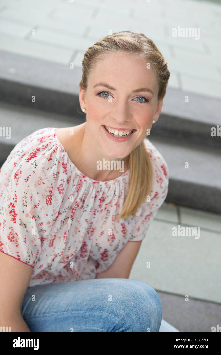Women sitting on stairs hi-res stock photography and images - Alamy
