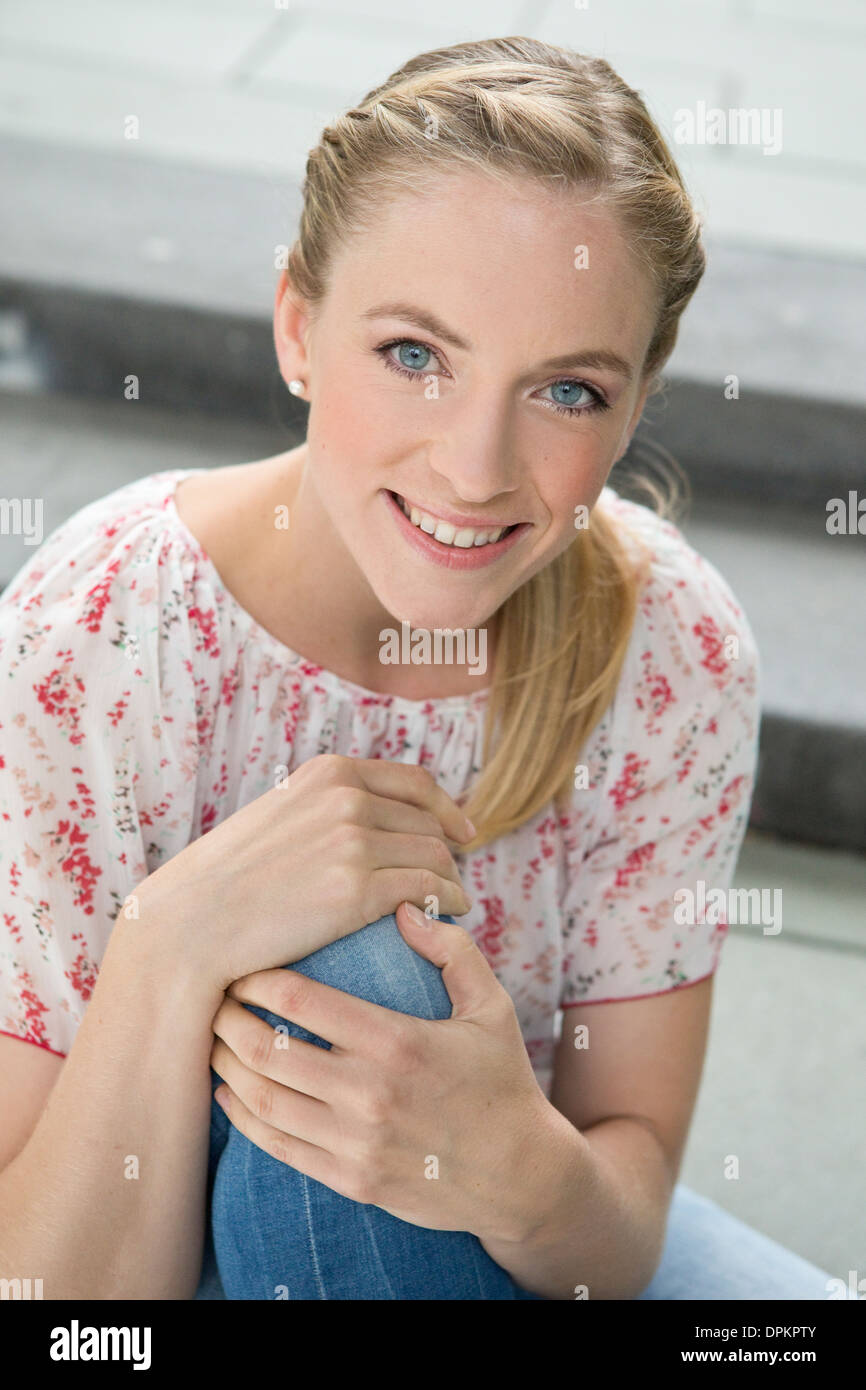 Young woman sitting on stairs hi-res stock photography and images - Alamy