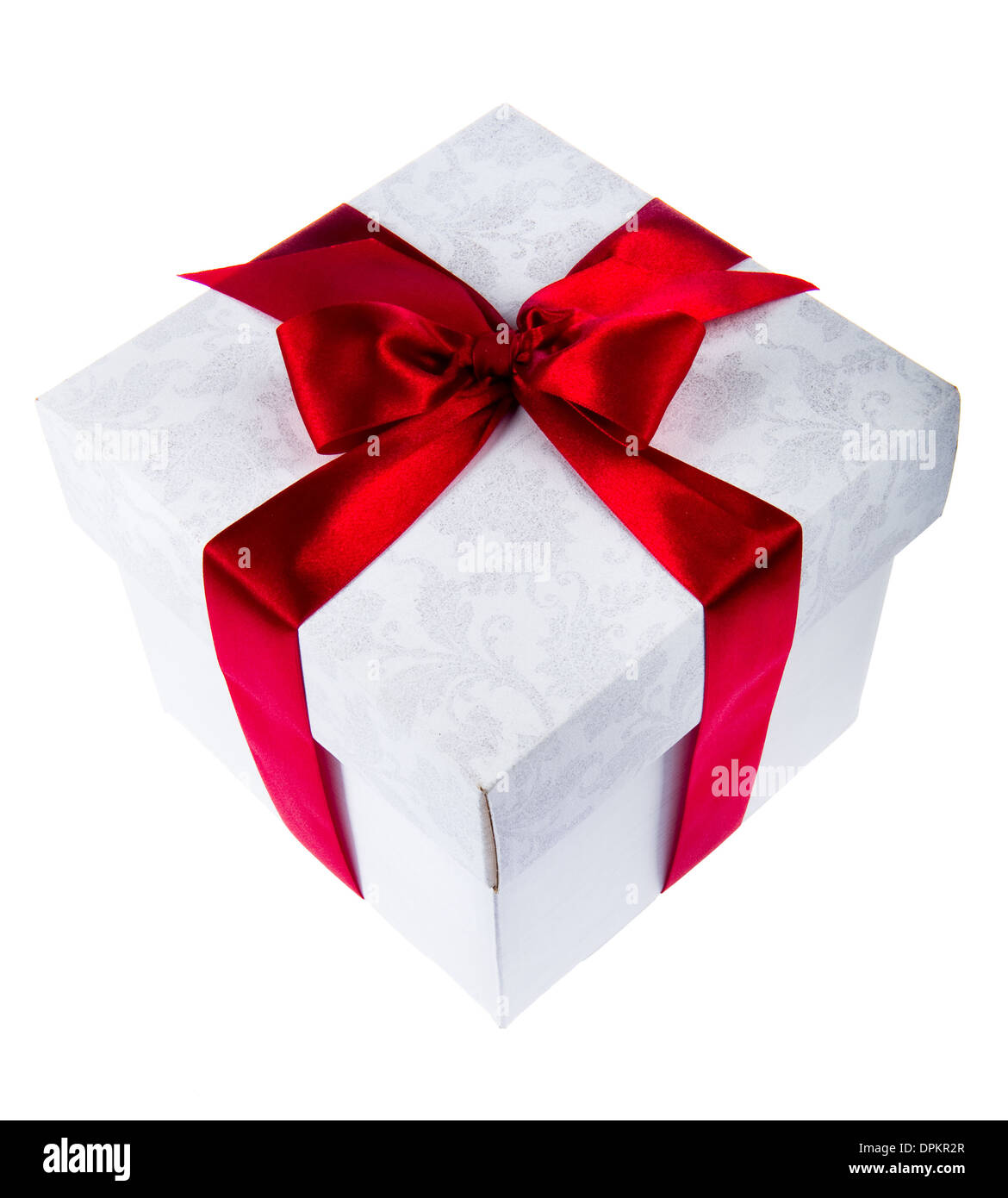 White gift box decorated with red ribbon Stock Photo - Alamy