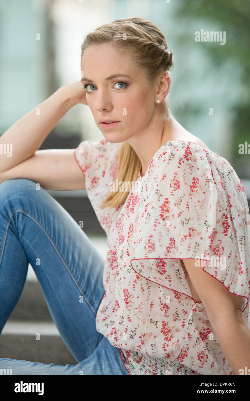 Woman sitting on stairs hi-res stock photography and images - Alamy