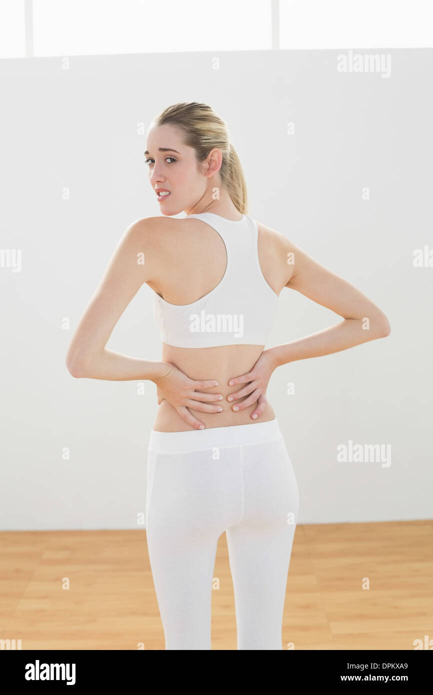 Woman touching her back hi-res stock photography and images - Alamy