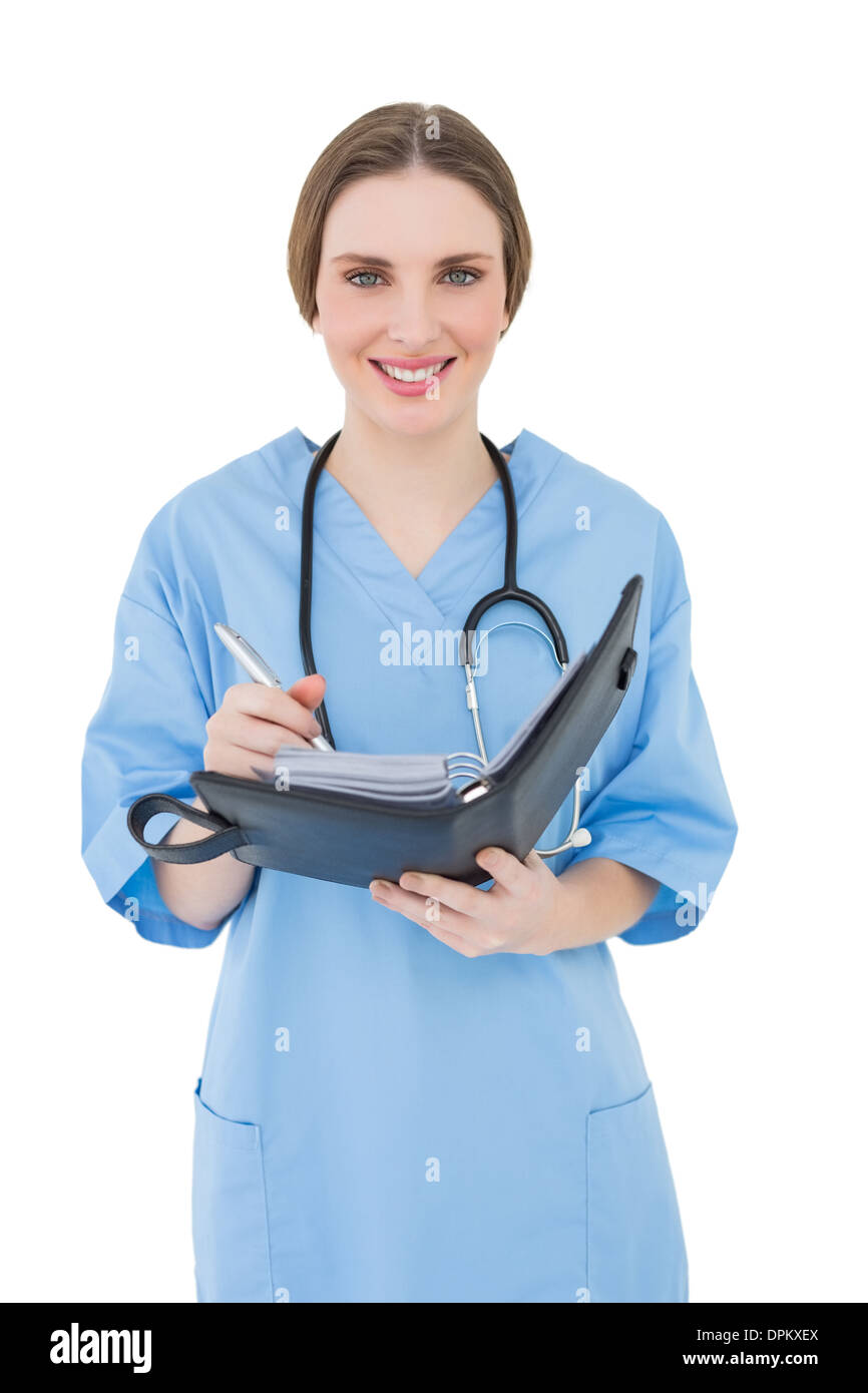 Female doctor writing into file Stock Photo - Alamy