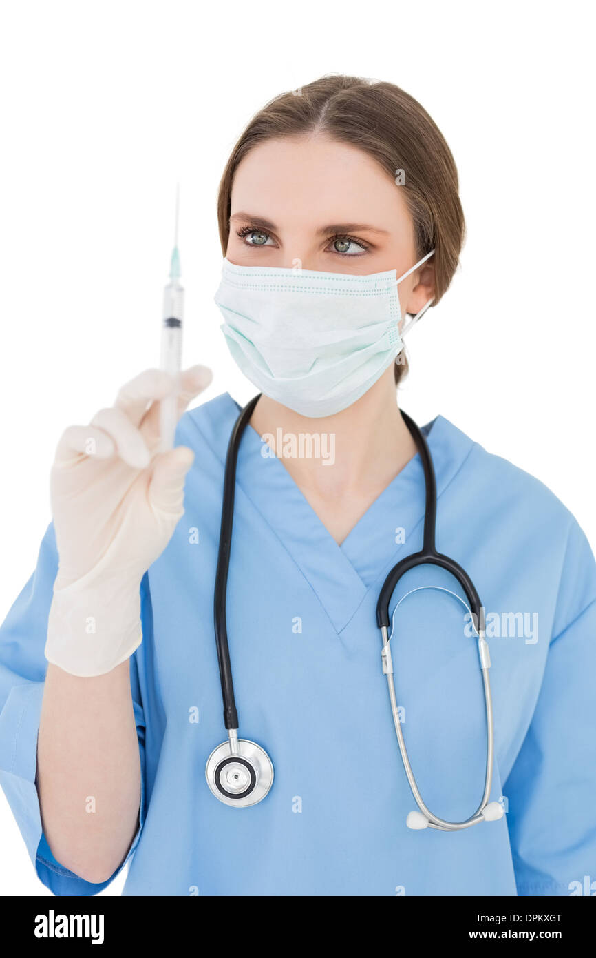 Young brunette woman doctor holding an injection Stock Photo - Alamy