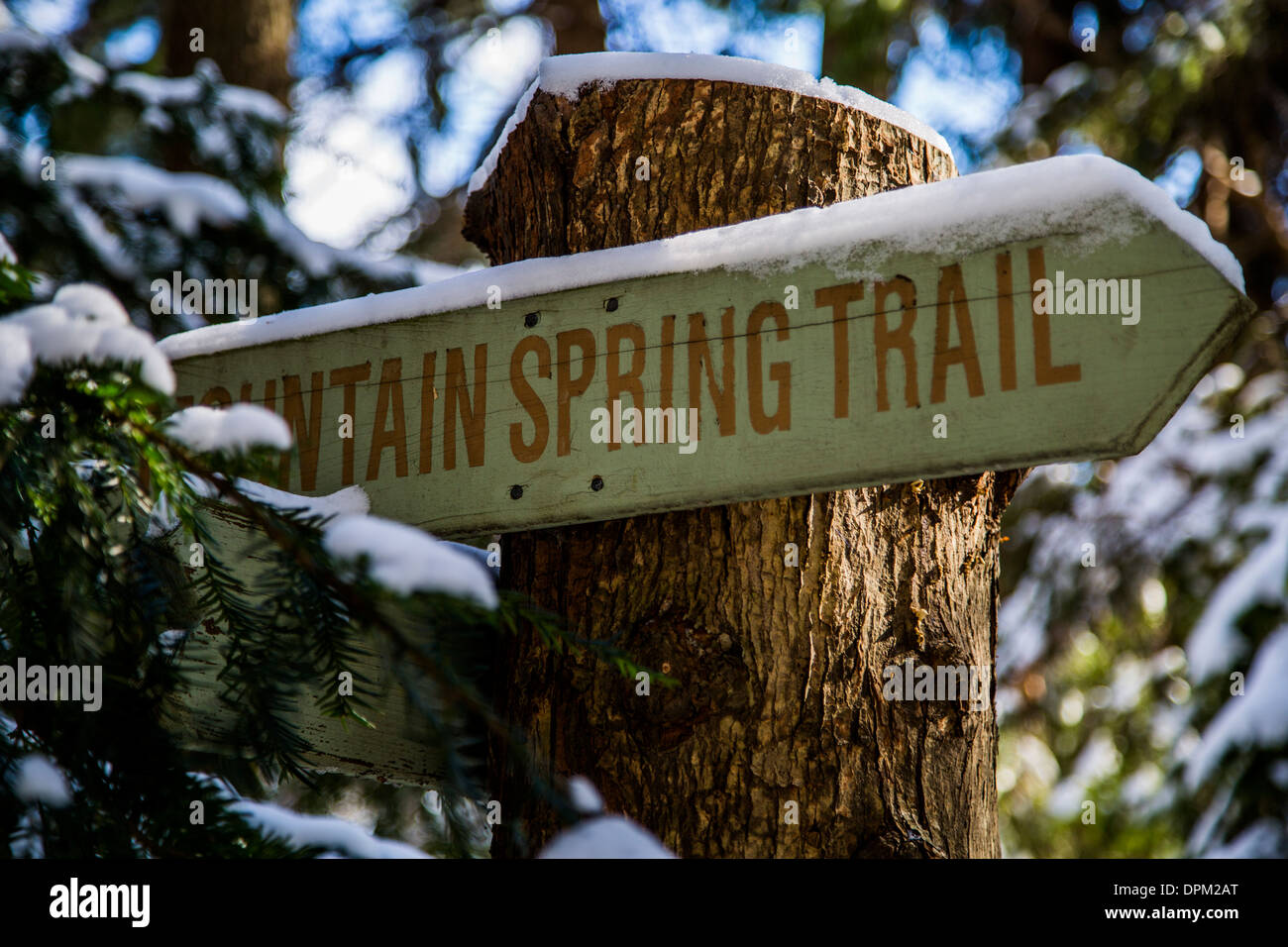 Hiking trail sign covered in snow Stock Photo - Alamy