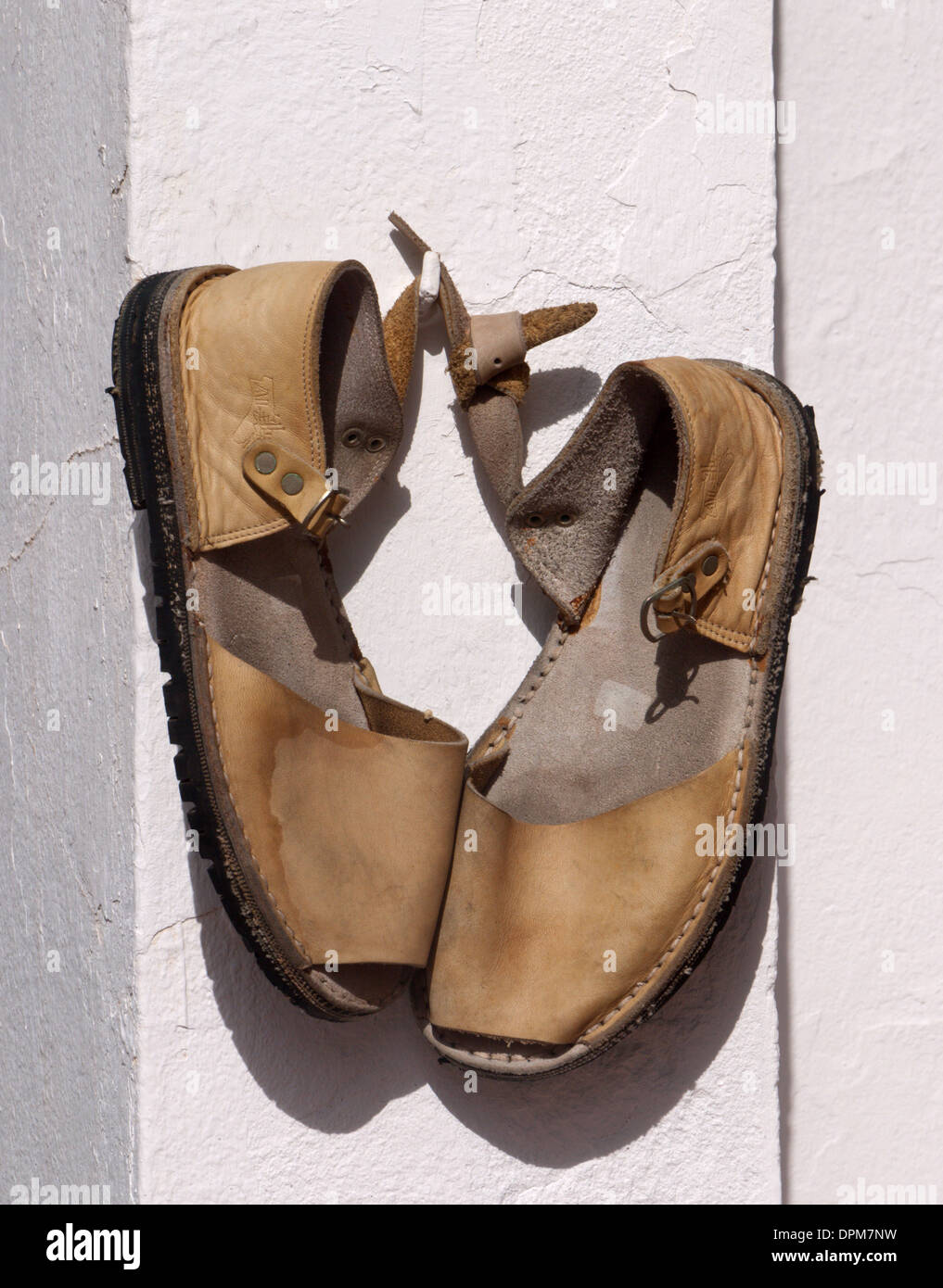 A pair of sandals hanging on the wall of a house in Menorca, Spain ...