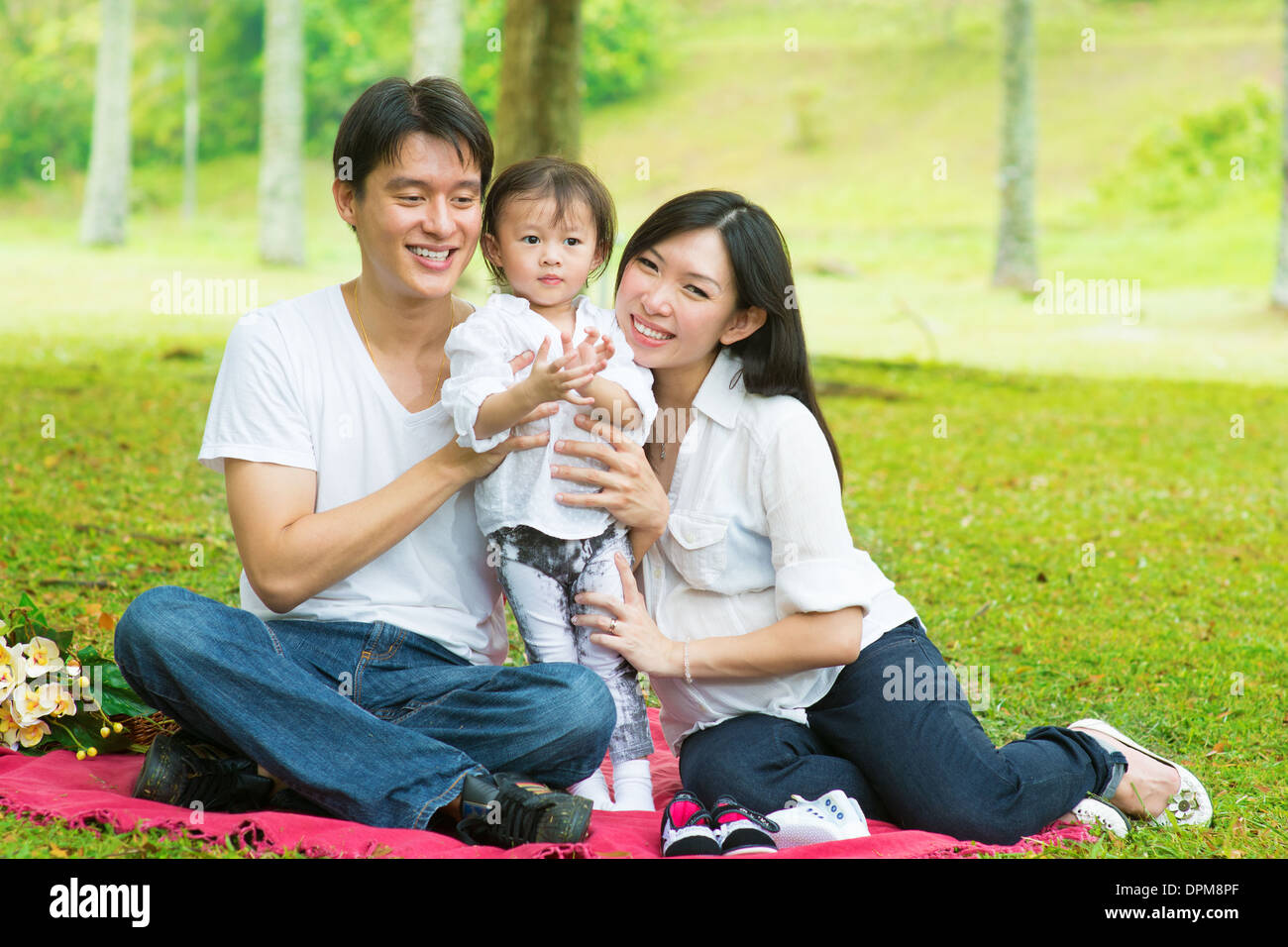 Happy Asian family outdoor activity. Parents and daughter having ...