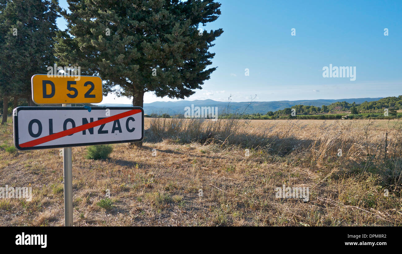 Olonzac boundary road sign with fields and the Pyrenees in the ...