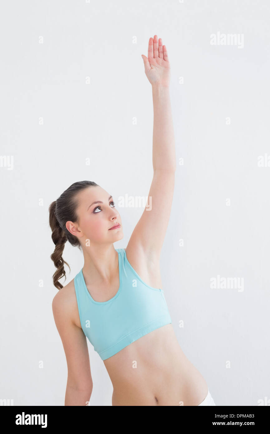 Sporty female stretching hand in fitness studio Stock Photo - Alamy