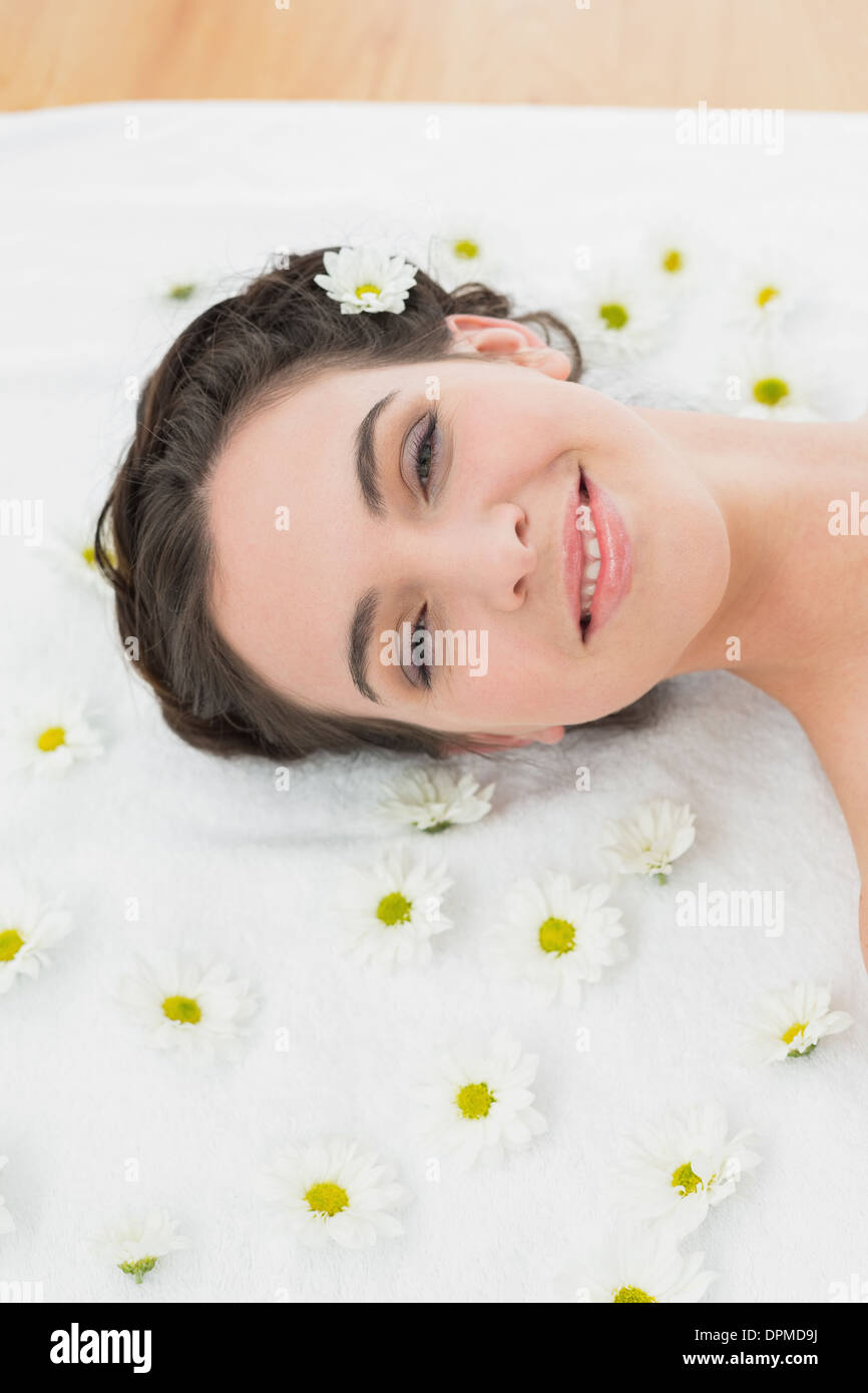 Beautiful young woman with flowers in beauty salon Stock Photo - Alamy