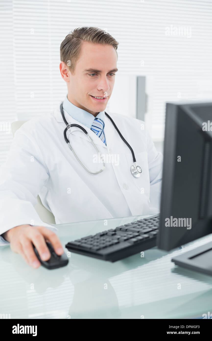 Male doctor using computer at medical office Stock Photo - Alamy