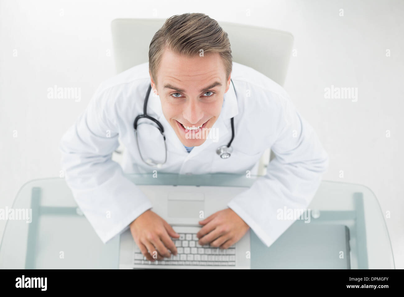 Overhead portrait of a smiling doctor using laptop Stock Photo - Alamy