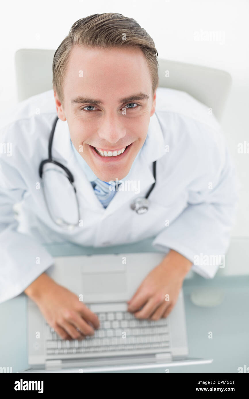 Doctor looking camera using laptop hi-res stock photography and images ...