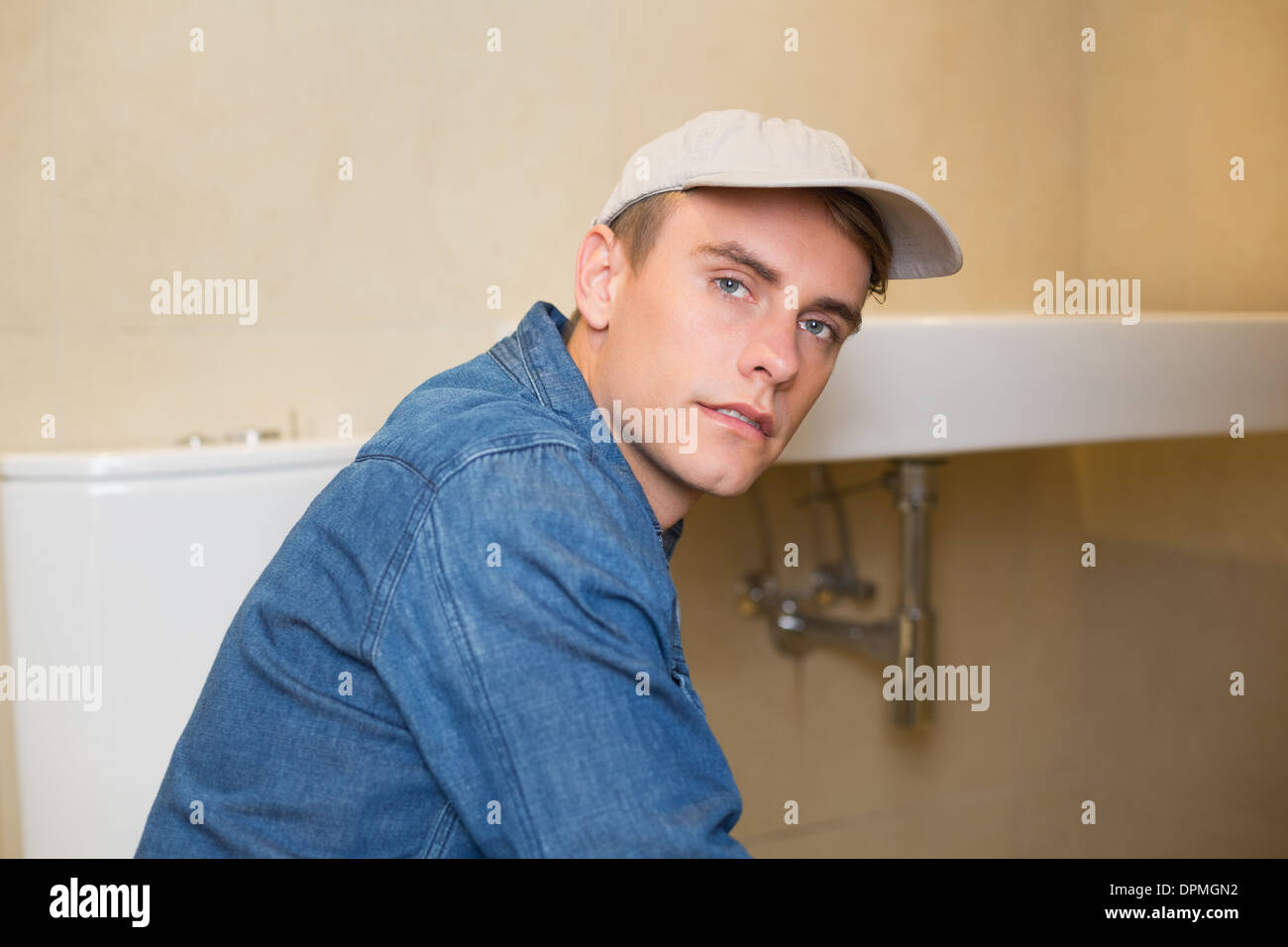 Serious male plumber by the sink Stock Photo - Alamy