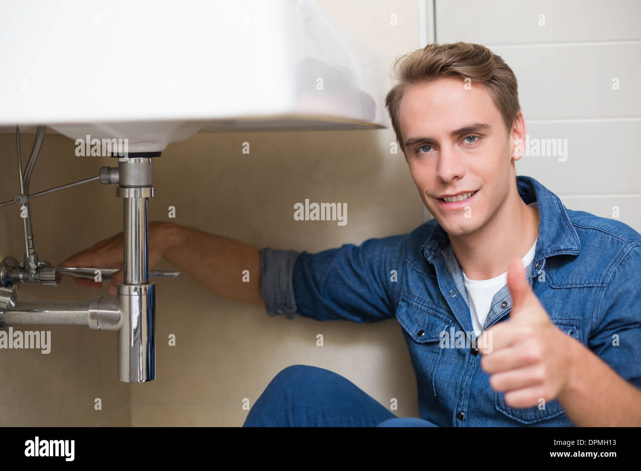 Handsome plumber repairing drain sink hi-res stock photography and ...