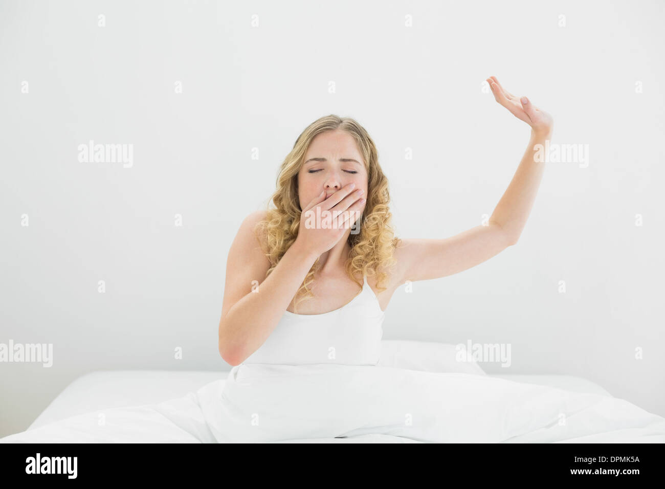 Yawning woman covering mouth hand hi-res stock photography and images ...