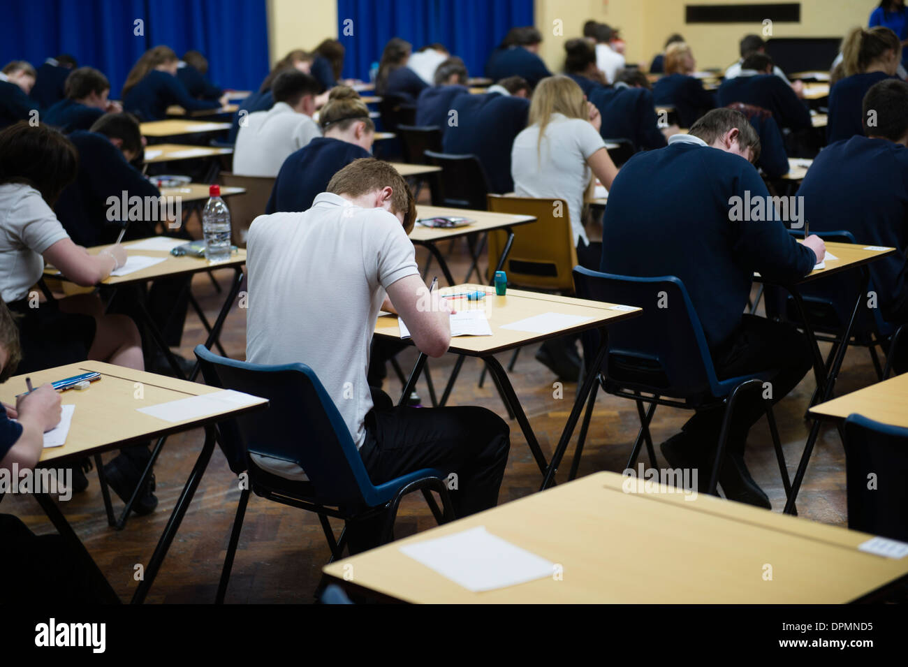 Welsh teenage GCSE school pupils sitting exams in a school hall, Wales ...