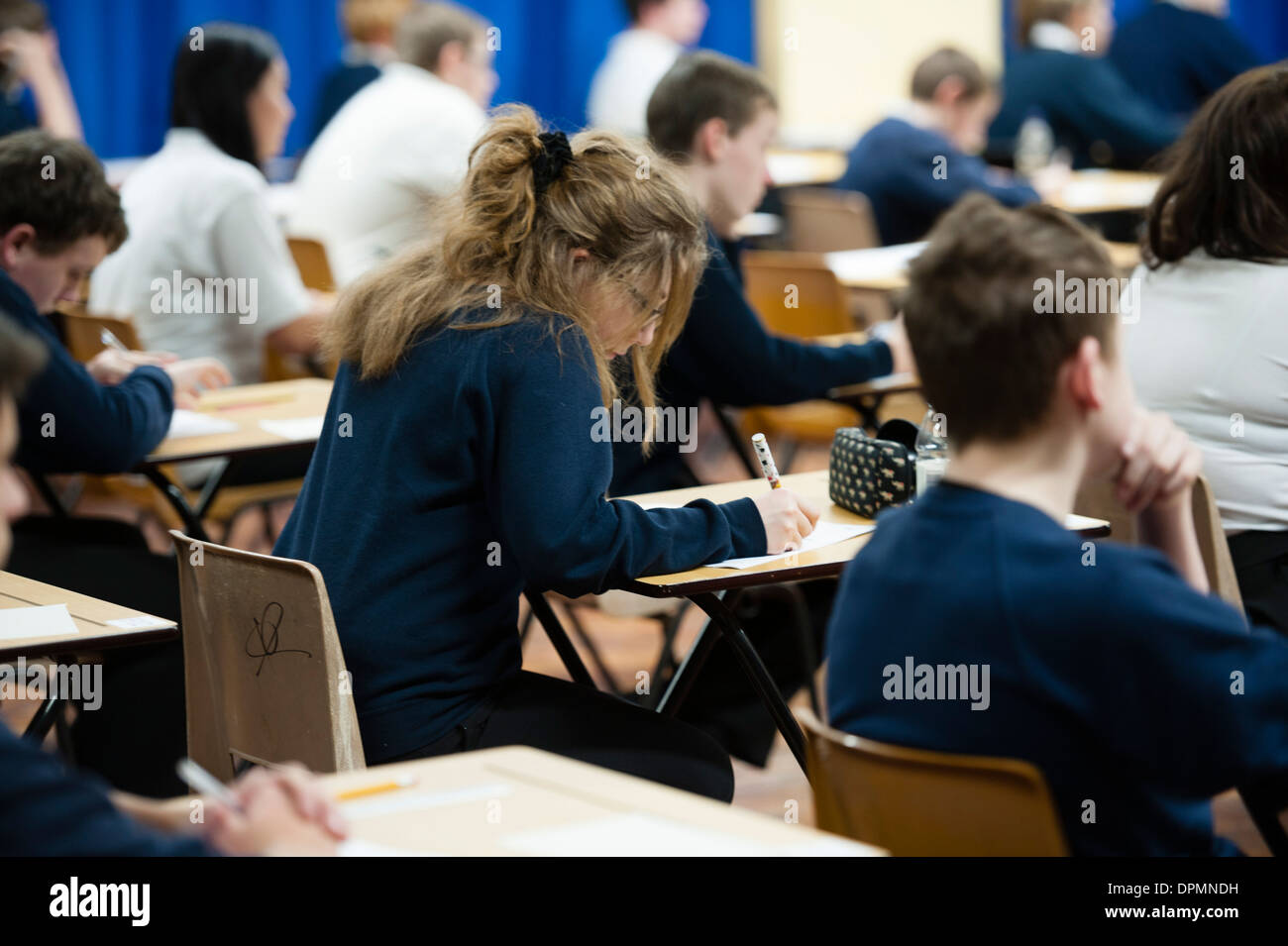 Welsh teenage GCSE school pupils sitting exams in a school hall, Wales ...
