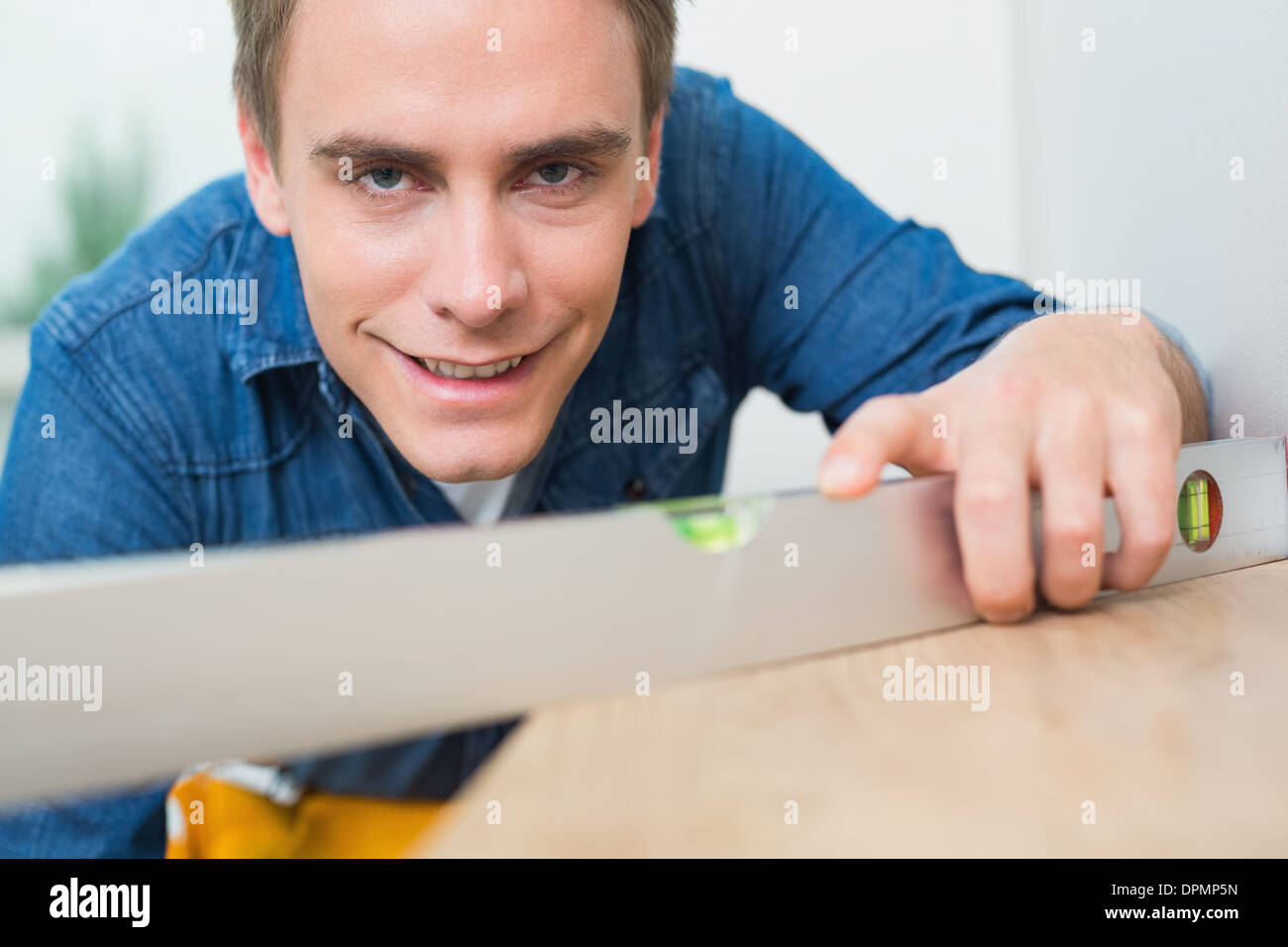 Young man using spirit level hi-res stock photography and images - Alamy