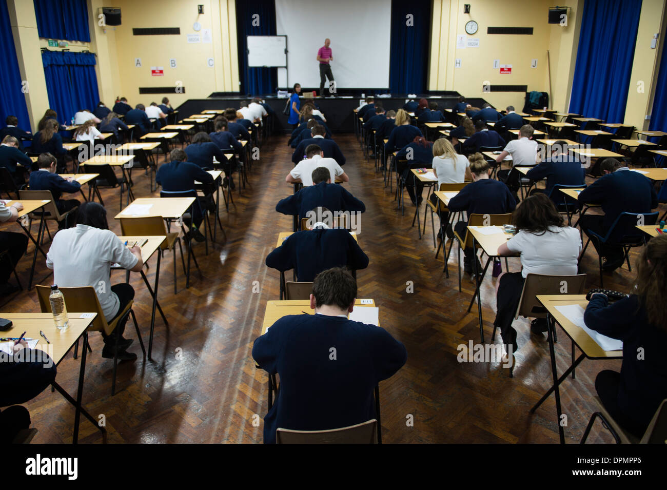 Welsh teenage GCSE school pupils sitting exams in a school hall, Wales ...