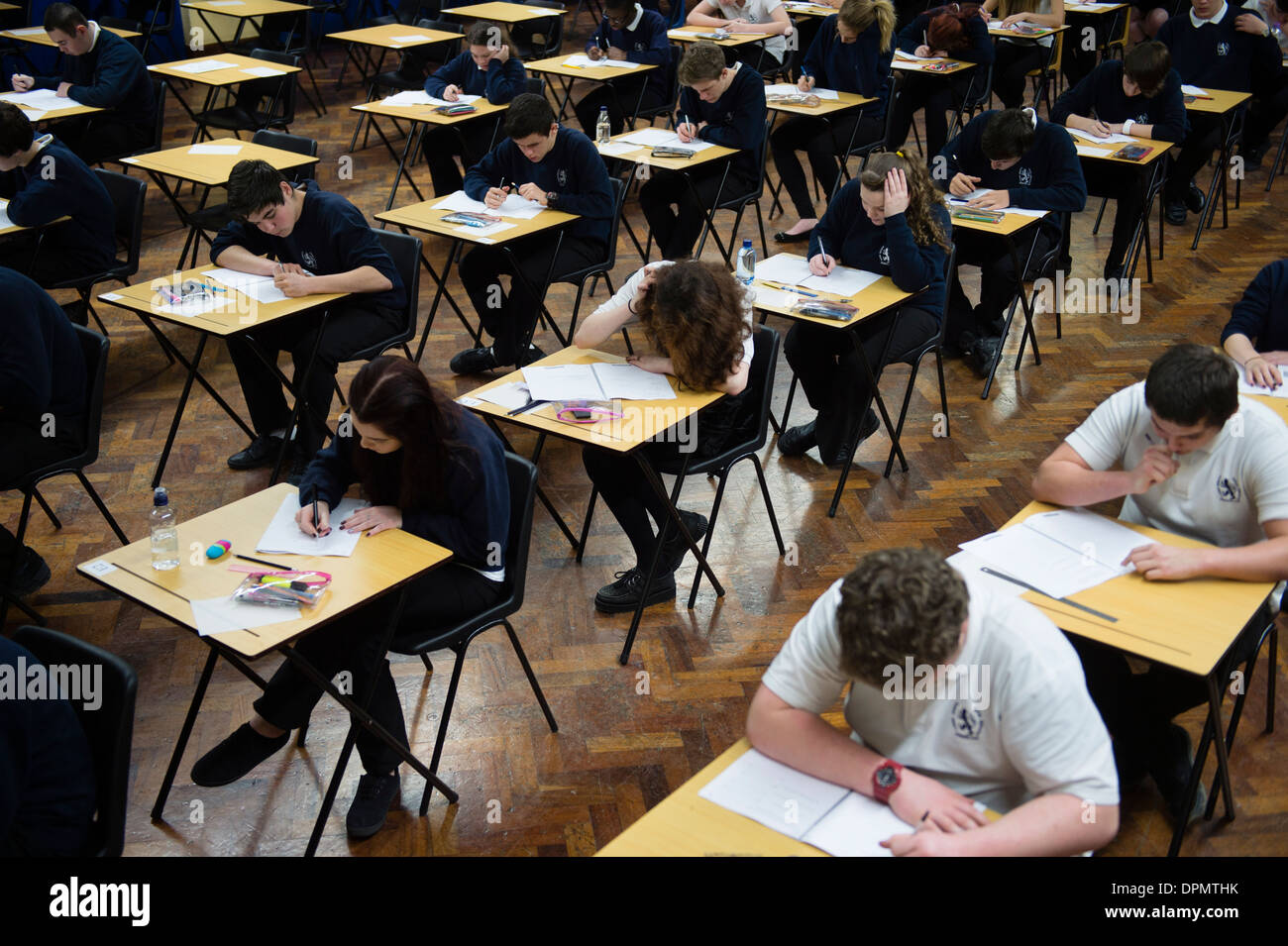 Welsh teenage GCSE school pupils sitting exams in a school hall, Wales ...