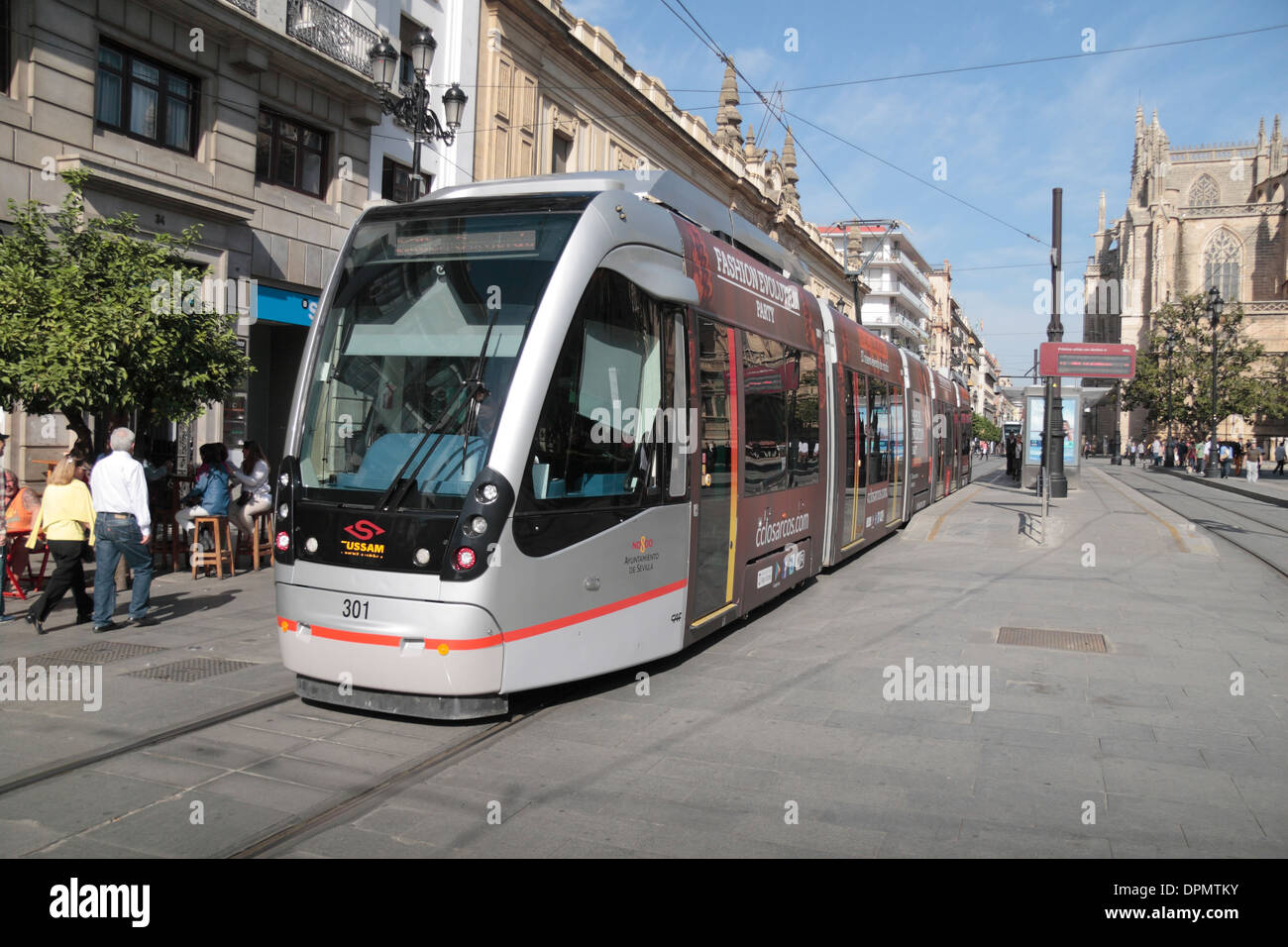 Tram passing Seville Cathedral on Avenue de la Constitución in Seville ...