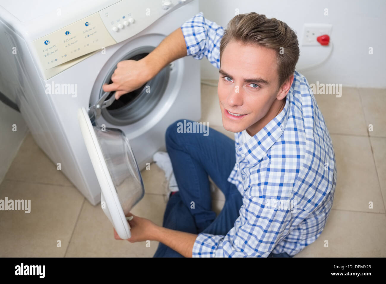 Technician repairing a washing machine Stock Photo - Alamy