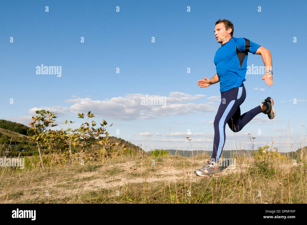 Man jogging on a dirt road Stock Photo - Alamy