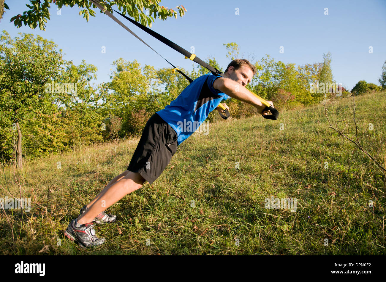 A man uses suspension rings Stock Photo - Alamy