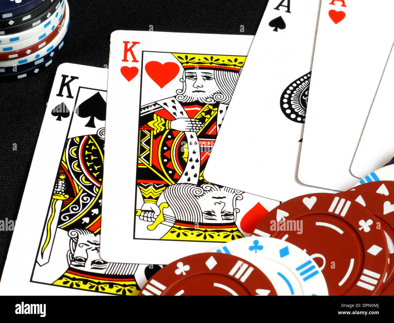Kings and aces surrounded by chips during a game of cards Stock Photo ...