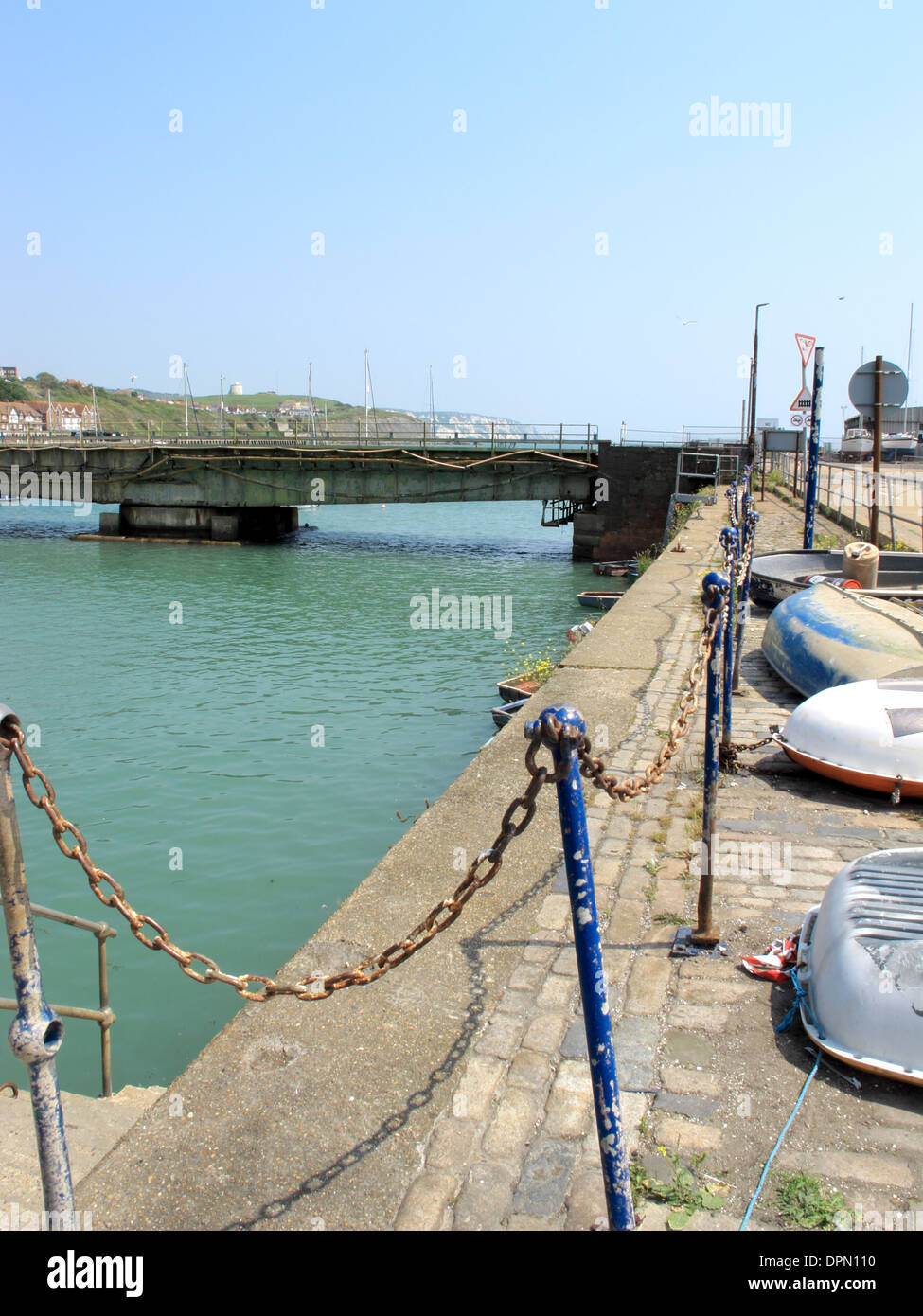 A landscape view showing the old boats and a bridge at Folkestone ...