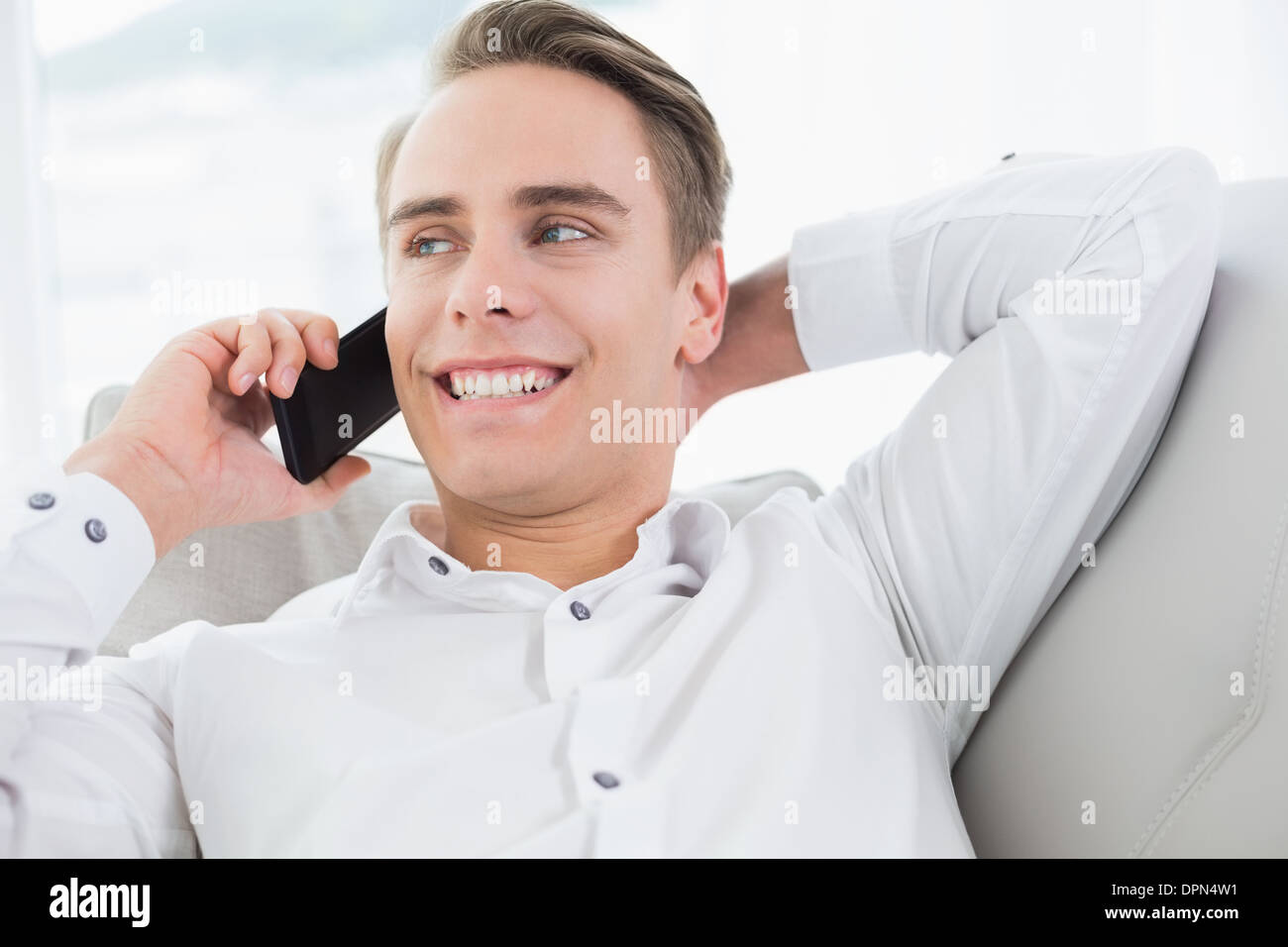 Relaxed young man looking mobile hi-res stock photography and images ...