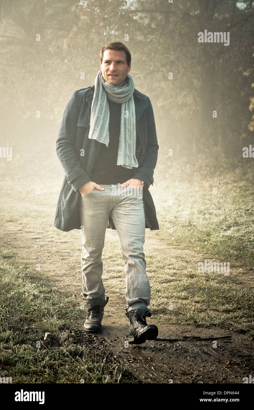 One person walking along a path into the mist hi-res stock photography ...