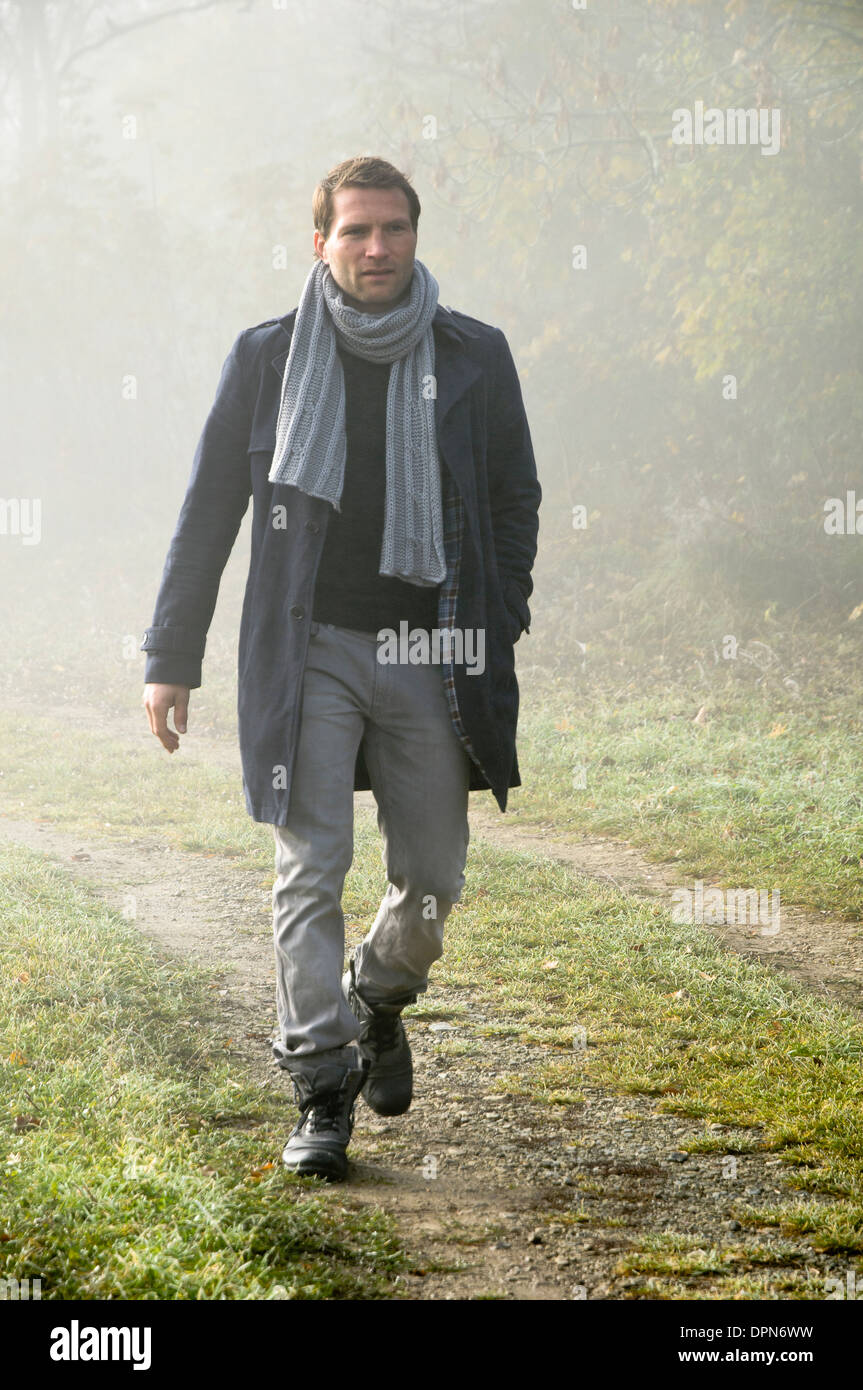 Man going nonchalantly along a path Stock Photo - Alamy