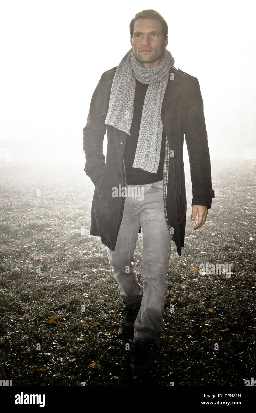 One person walking along a path into the mist hi-res stock photography ...