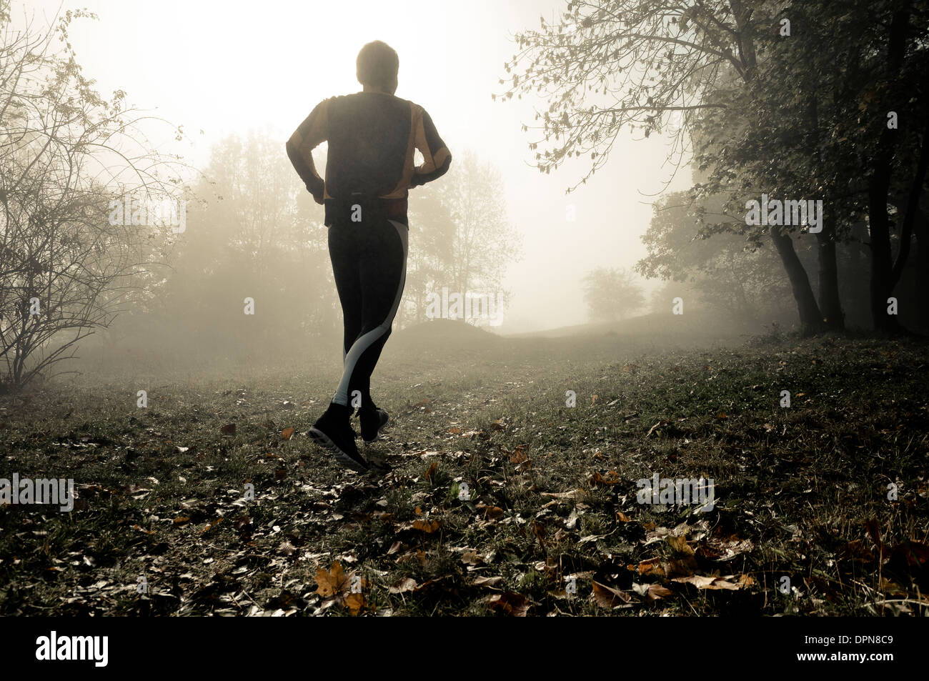 Man running through the forest Stock Photo - Alamy