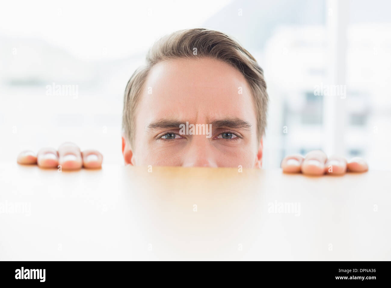 Man peeking over wall hi-res stock photography and images - Alamy