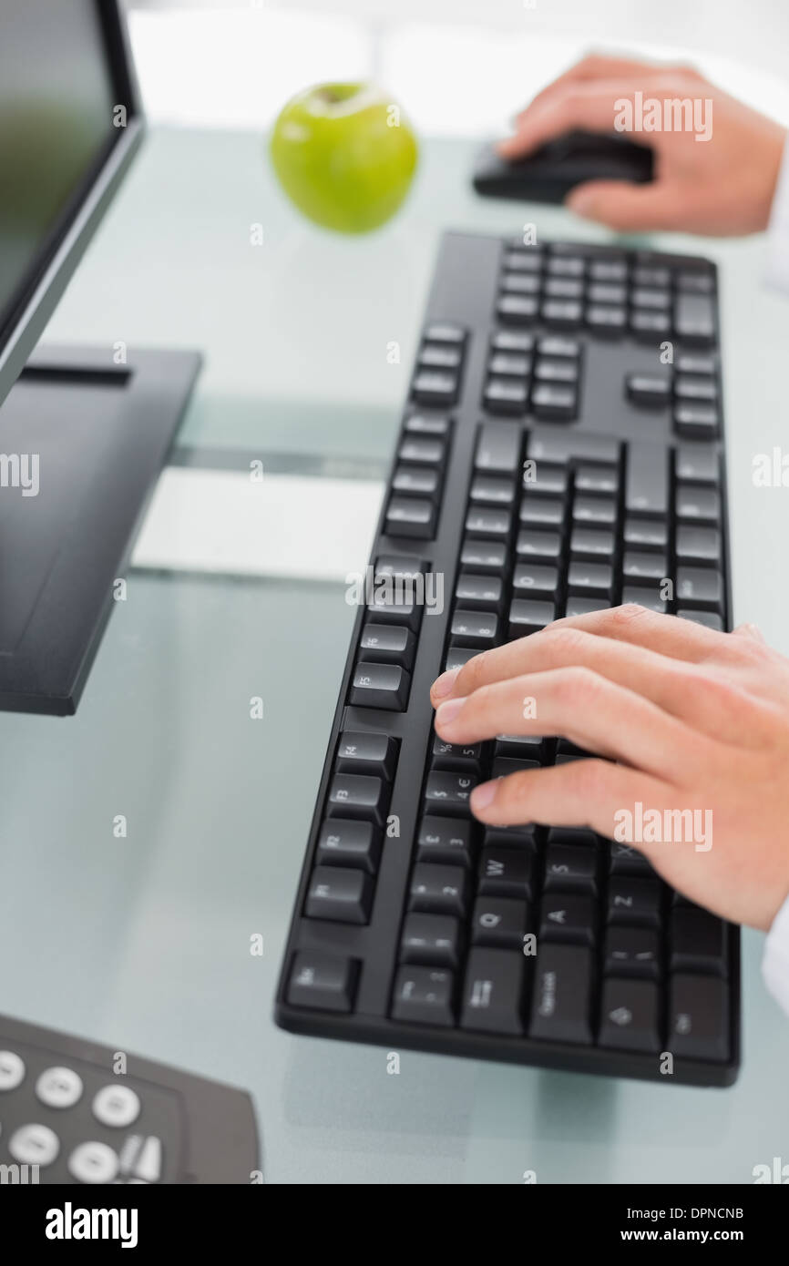 Hands using computer at medical office Stock Photo - Alamy