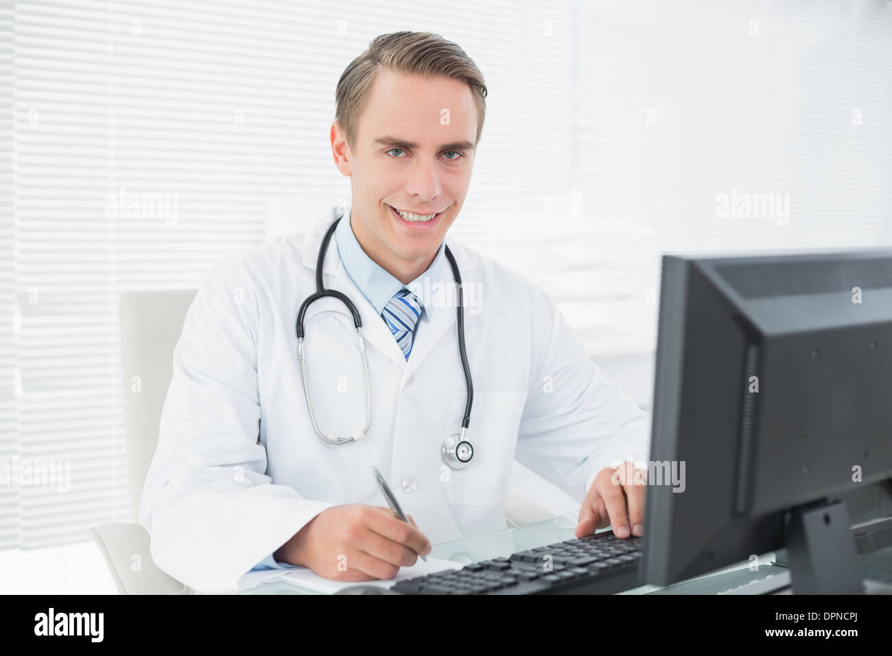 Smiling doctor computer using hi-res stock photography and images - Alamy