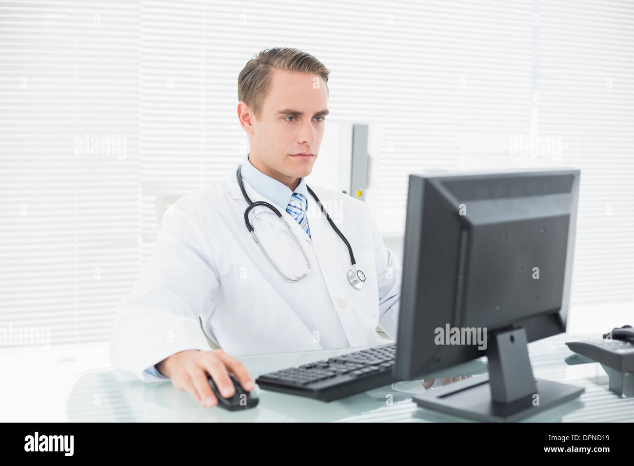 Doctor using computer at medical office Stock Photo - Alamy